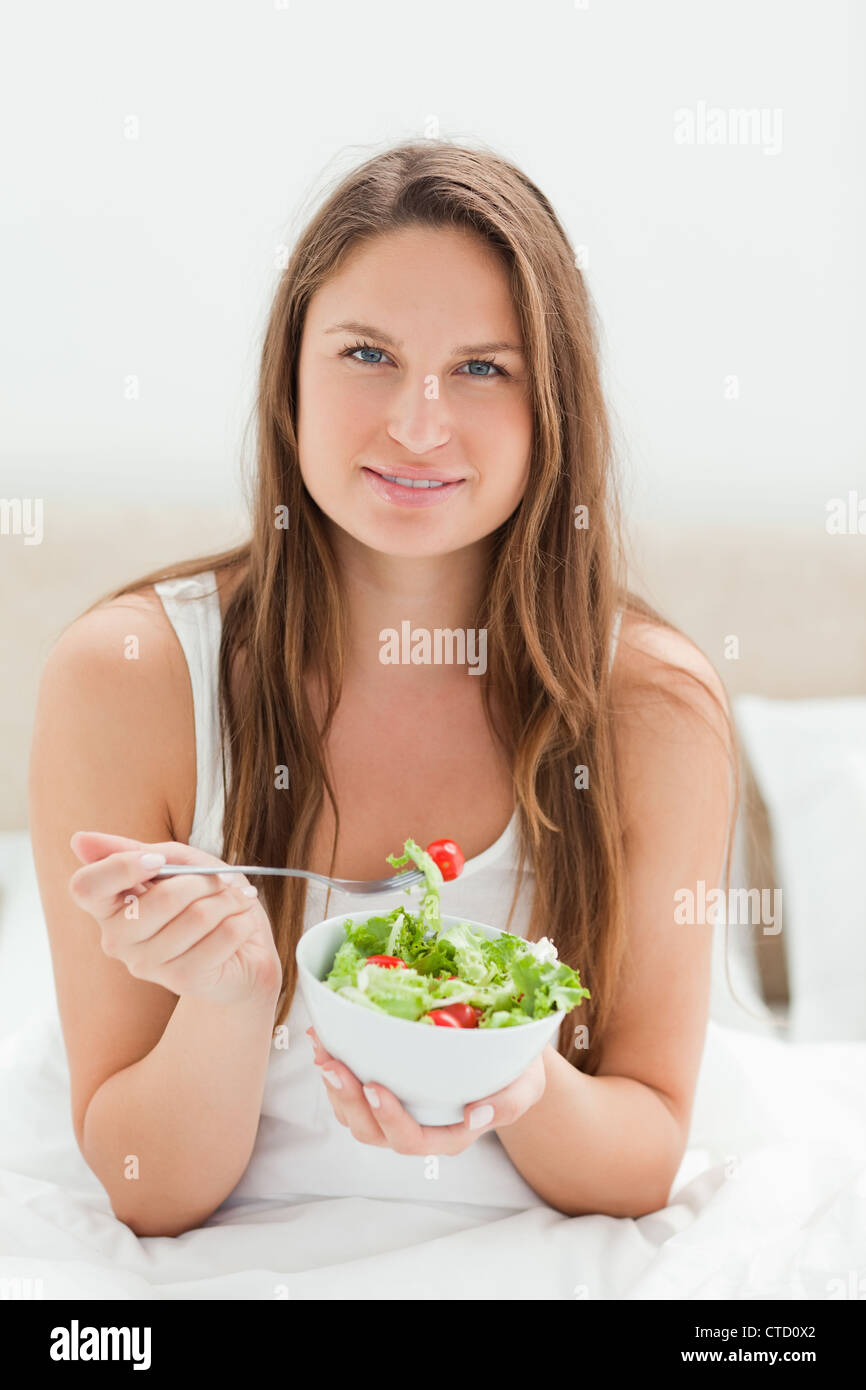 Young woman eating a salad Stock Photo - Alamy