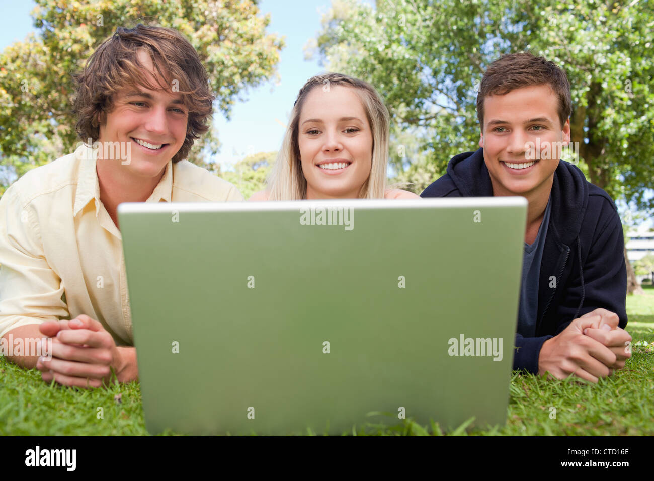 Three students lying outdoors hi-res stock photography and images - Alamy