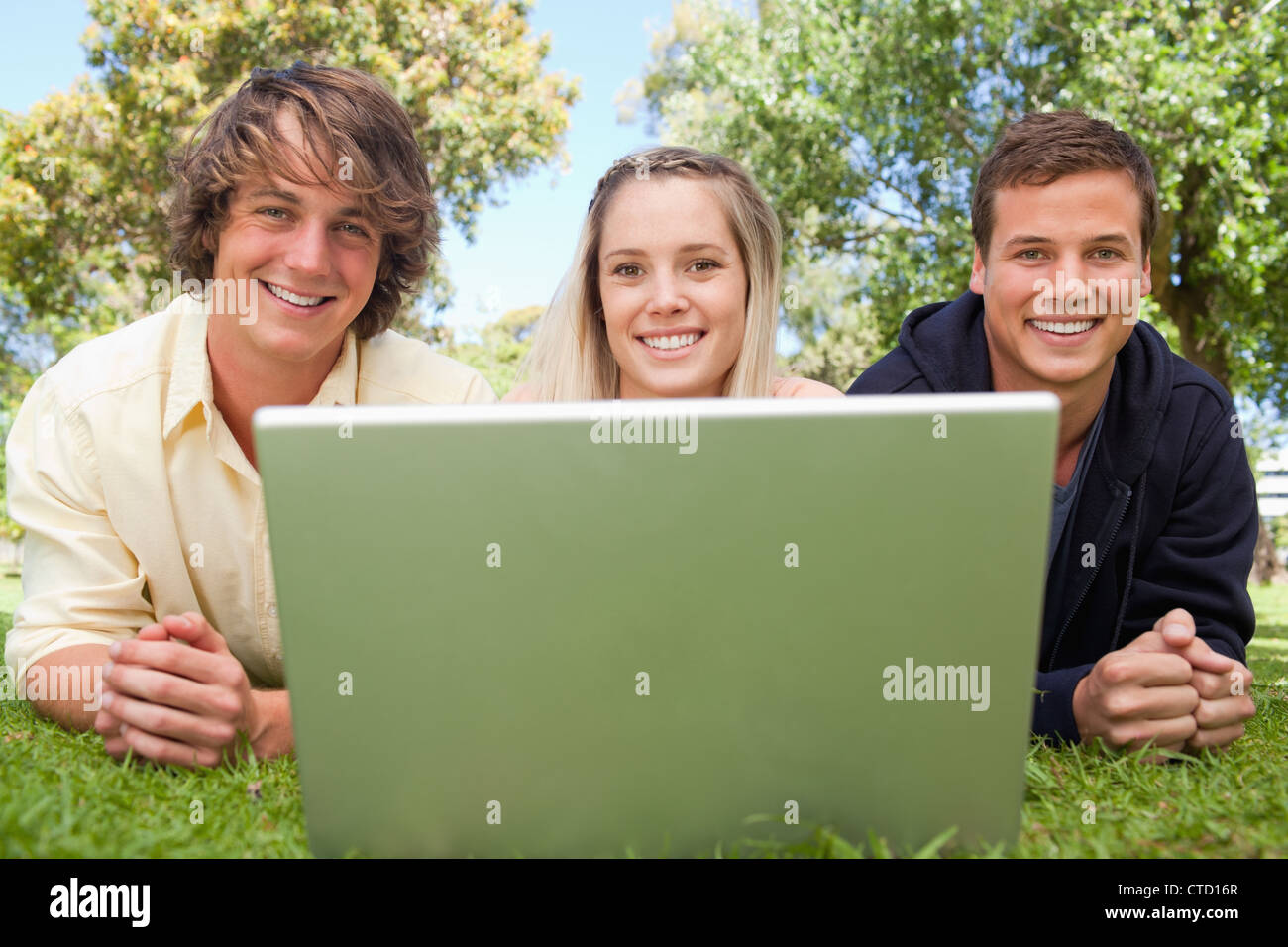 Three students lying outdoors hi-res stock photography and images - Alamy
