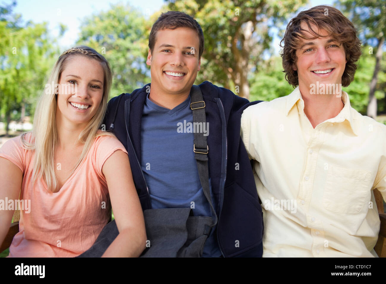 Portrait of three smiling students Stock Photo - Alamy