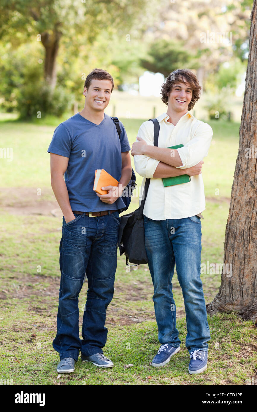Portrait of two happy standing male students Stock Photo - Alamy