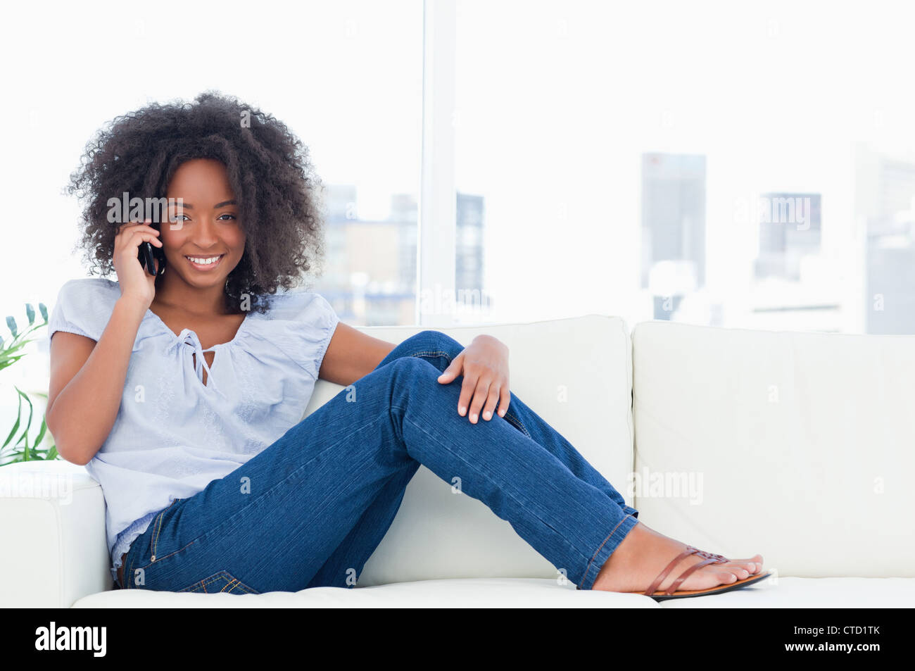 Close-up of a fuzzy hair woman calling Stock Photo - Alamy