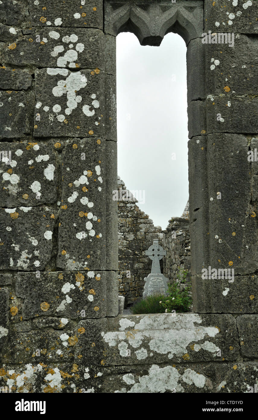 Memorial Cross viewed through window frame of the Old Church, Ruan, Co ...