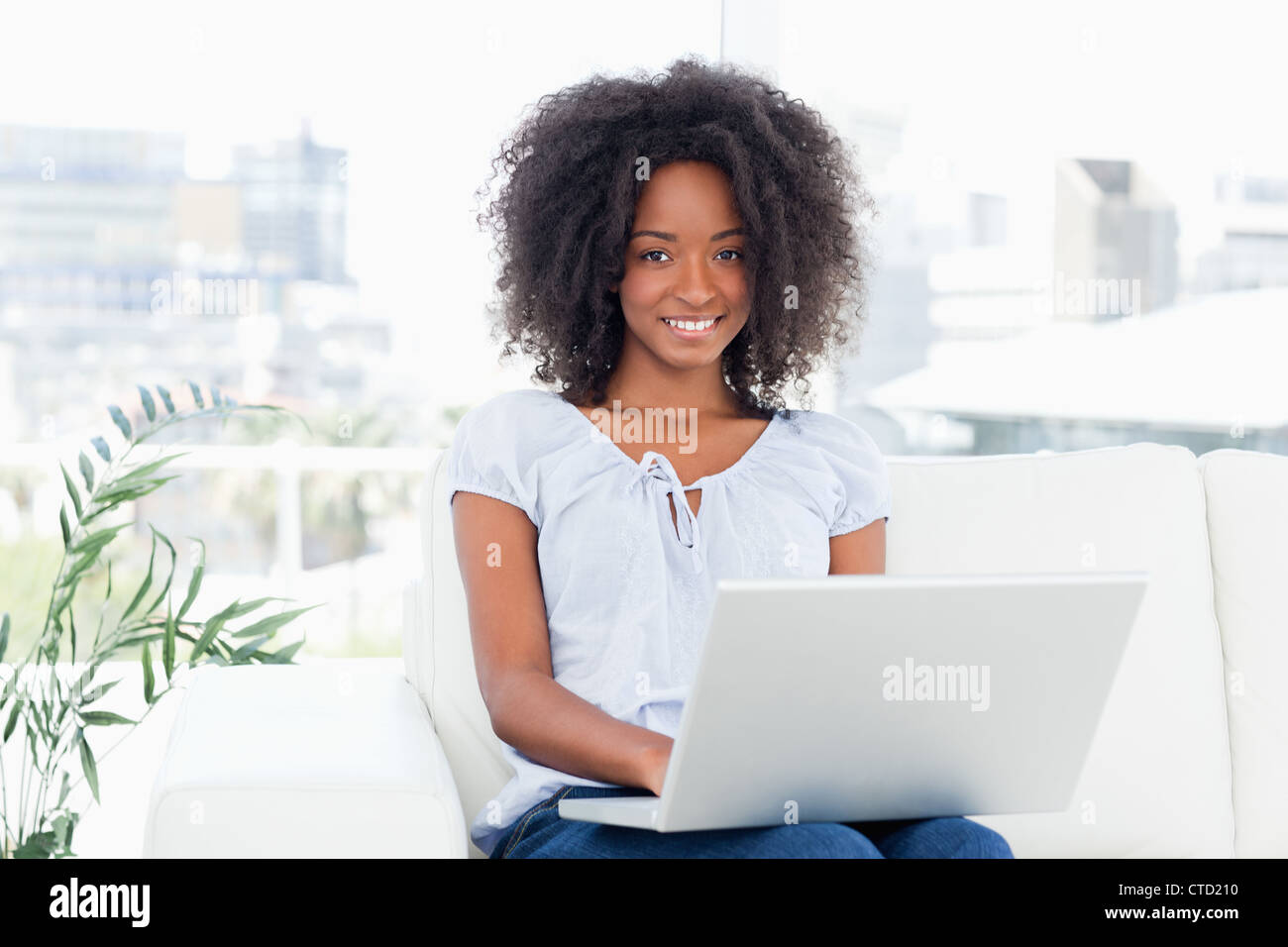 Cute fuzzy hair woman with a personal computer Stock Photo - Alamy