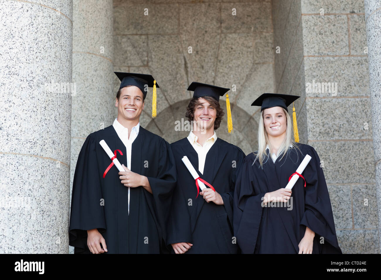 Portrait of graduates holding their diploma Stock Photo - Alamy