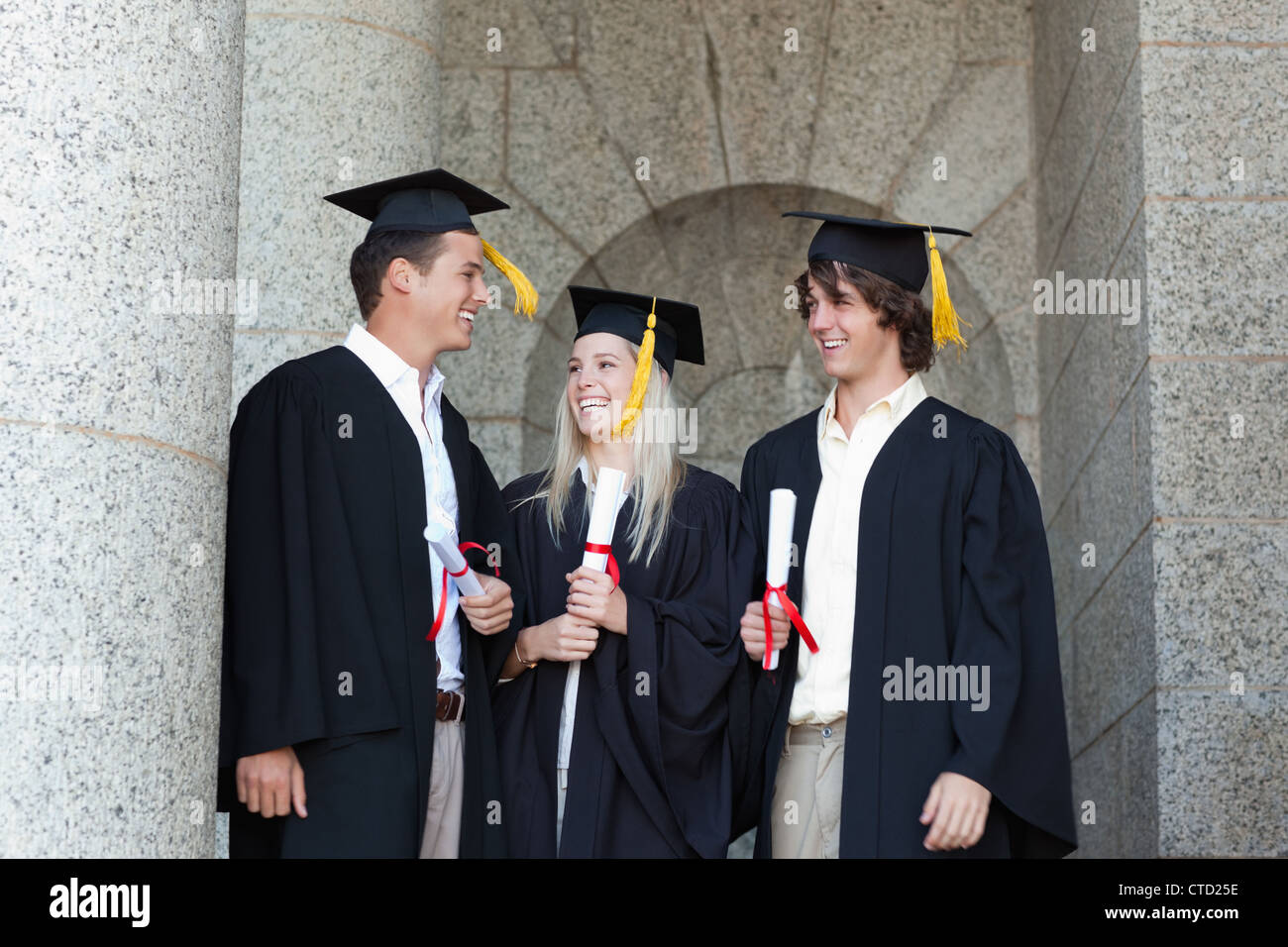Happy graduates speaking together Stock Photo - Alamy