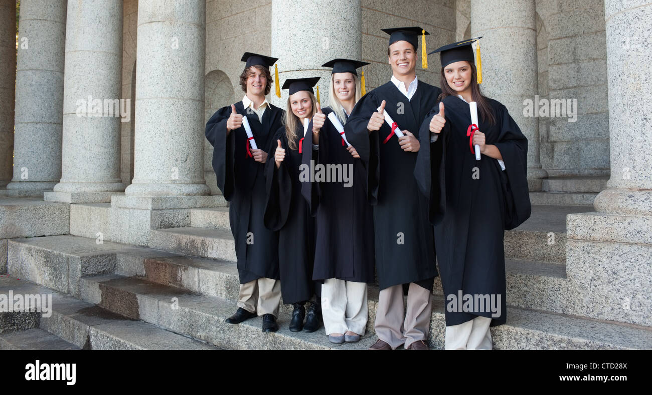Five happy graduates posing the thumb-up Stock Photo - Alamy