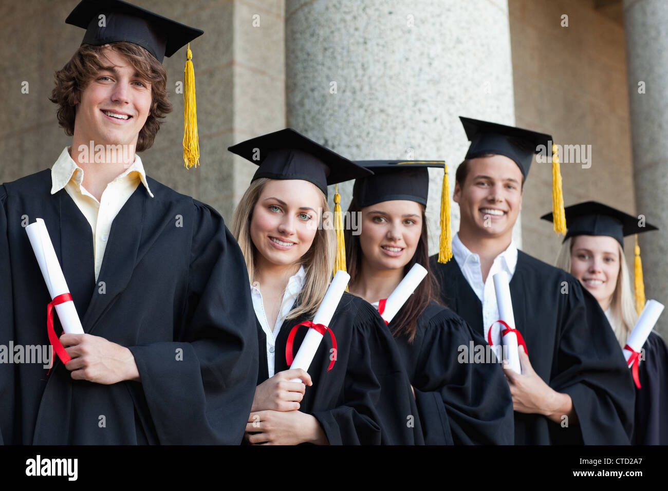 Close-up of five graduates students posing Stock Photo - Alamy