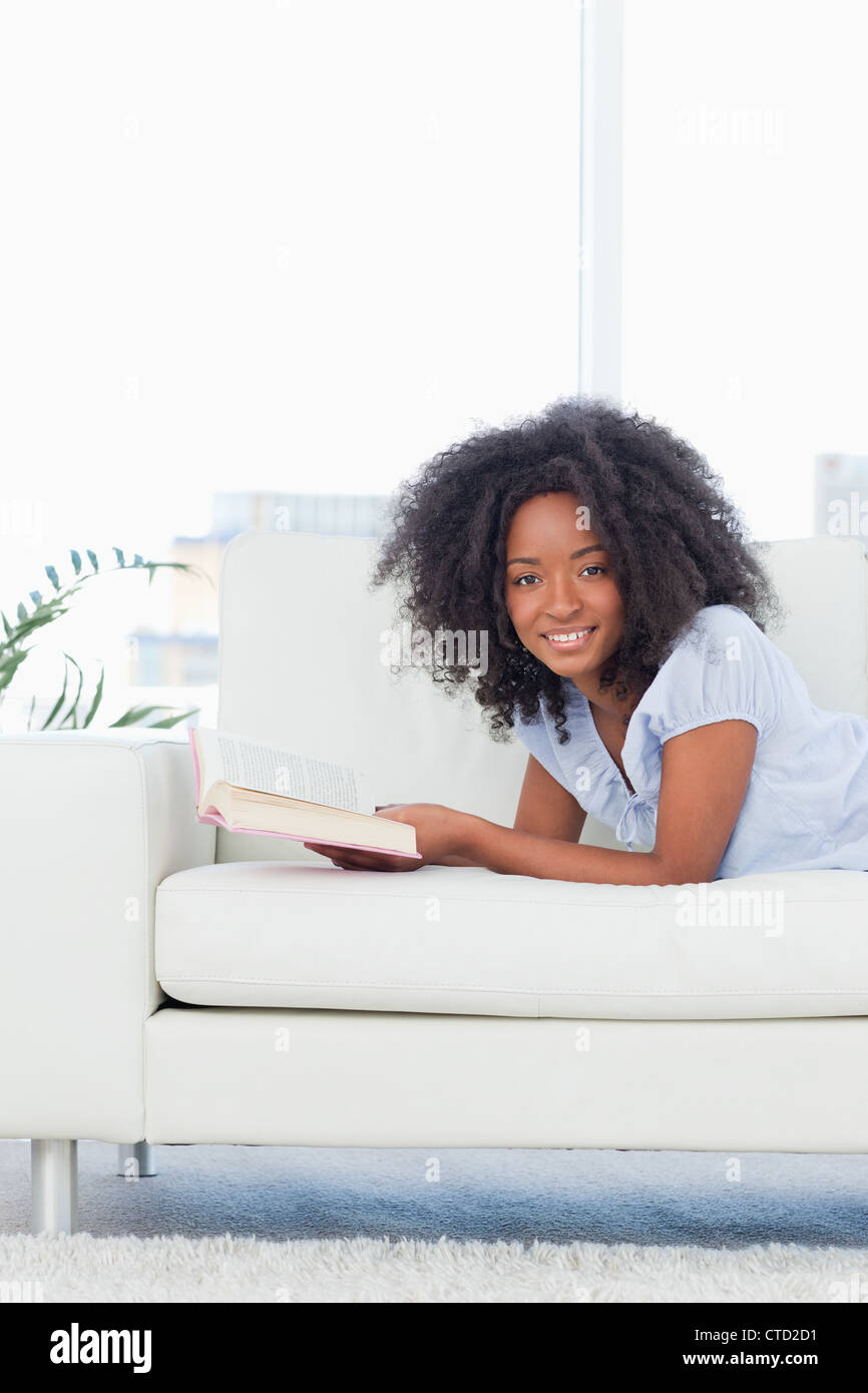 Portrait of a cute woman reading a book Stock Photo - Alamy