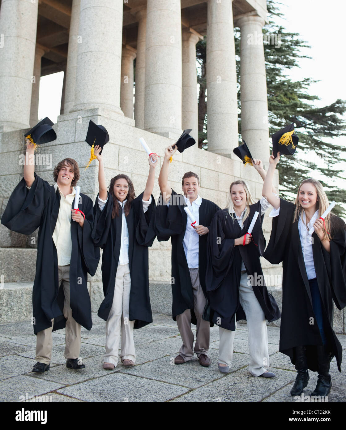 Five happy grad students raising their hats Stock Photo - Alamy