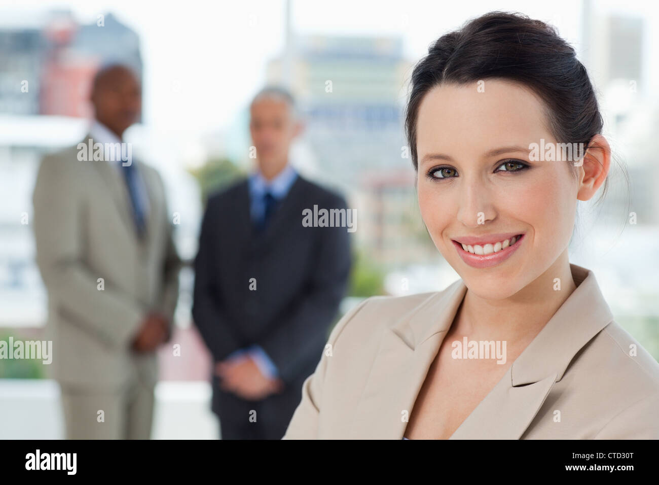 Secretary standing upright in a relaxed way and showing a great smile ...