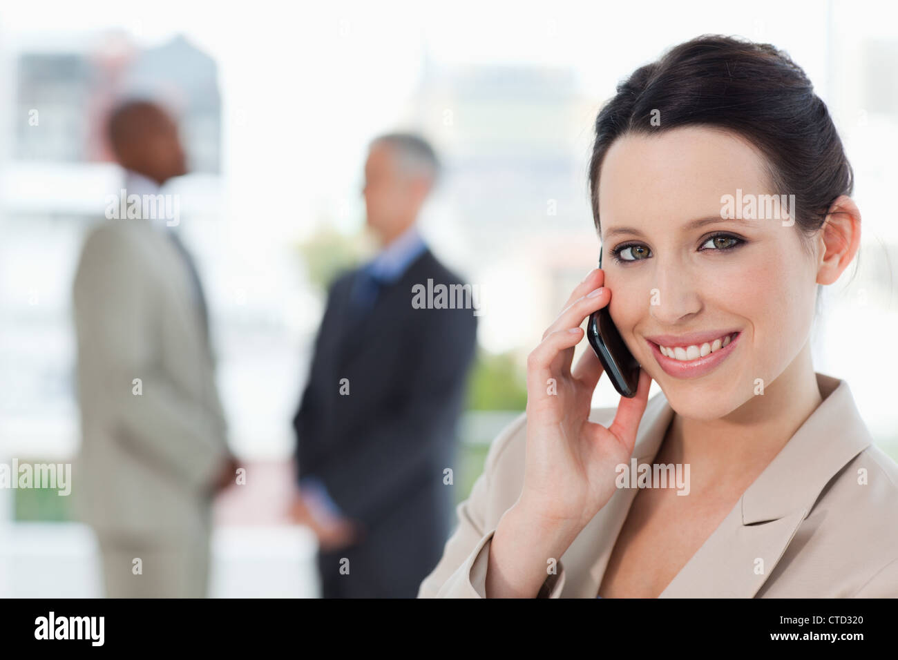 Secretary talking on the phone while looking at the camera Stock Photo ...