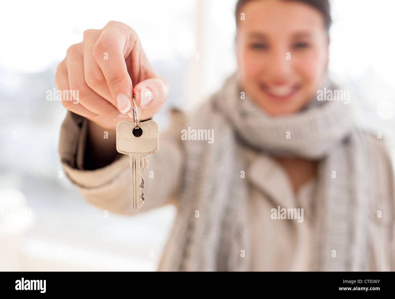 Happy woman with a key Stock Photo - Alamy