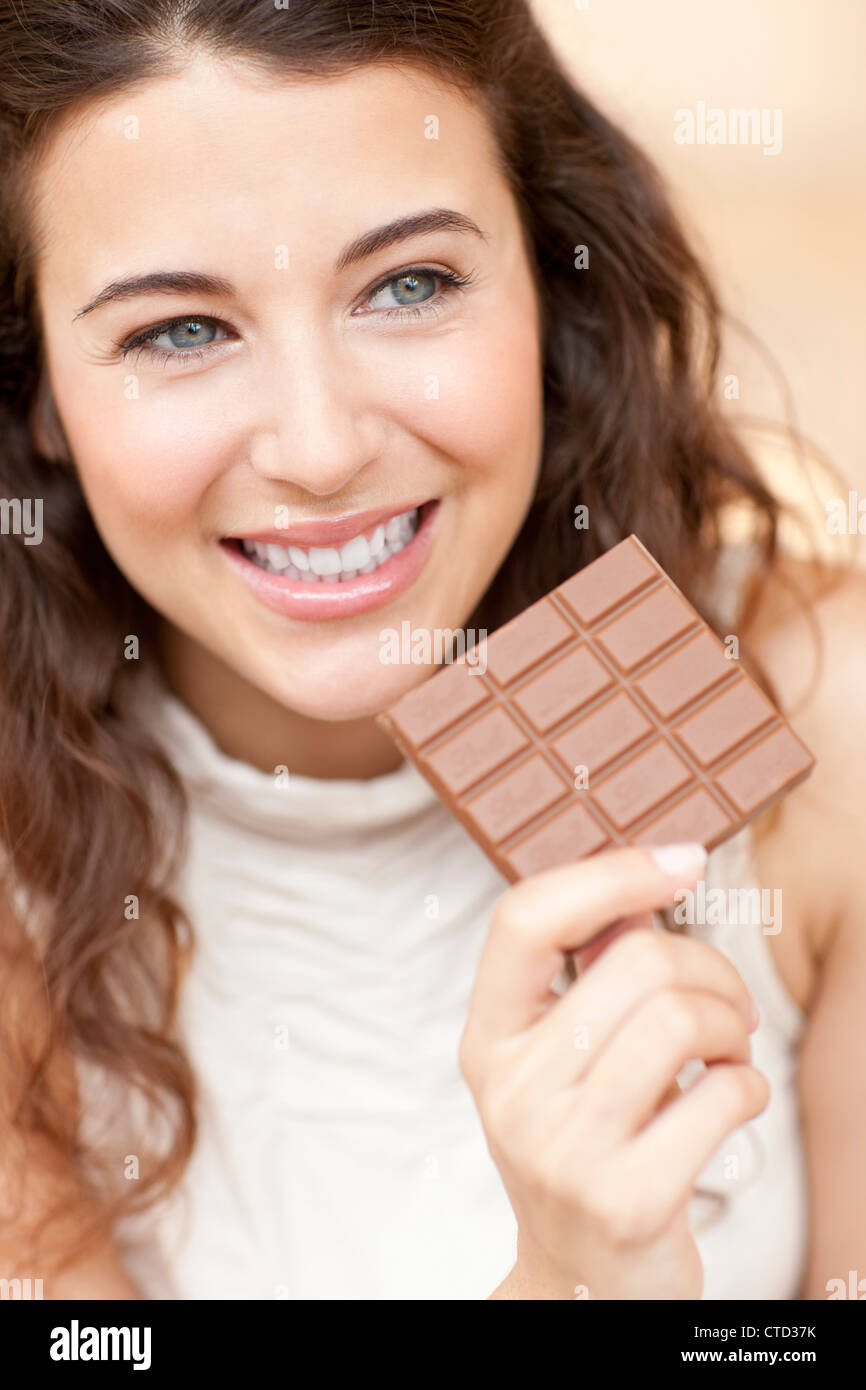 Woman eating chocolate Stock Photo - Alamy