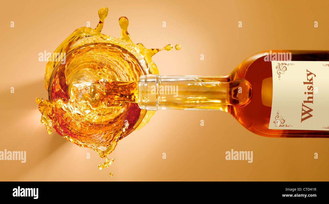 single malt whisky spashes into glass Stock Photo - Alamy