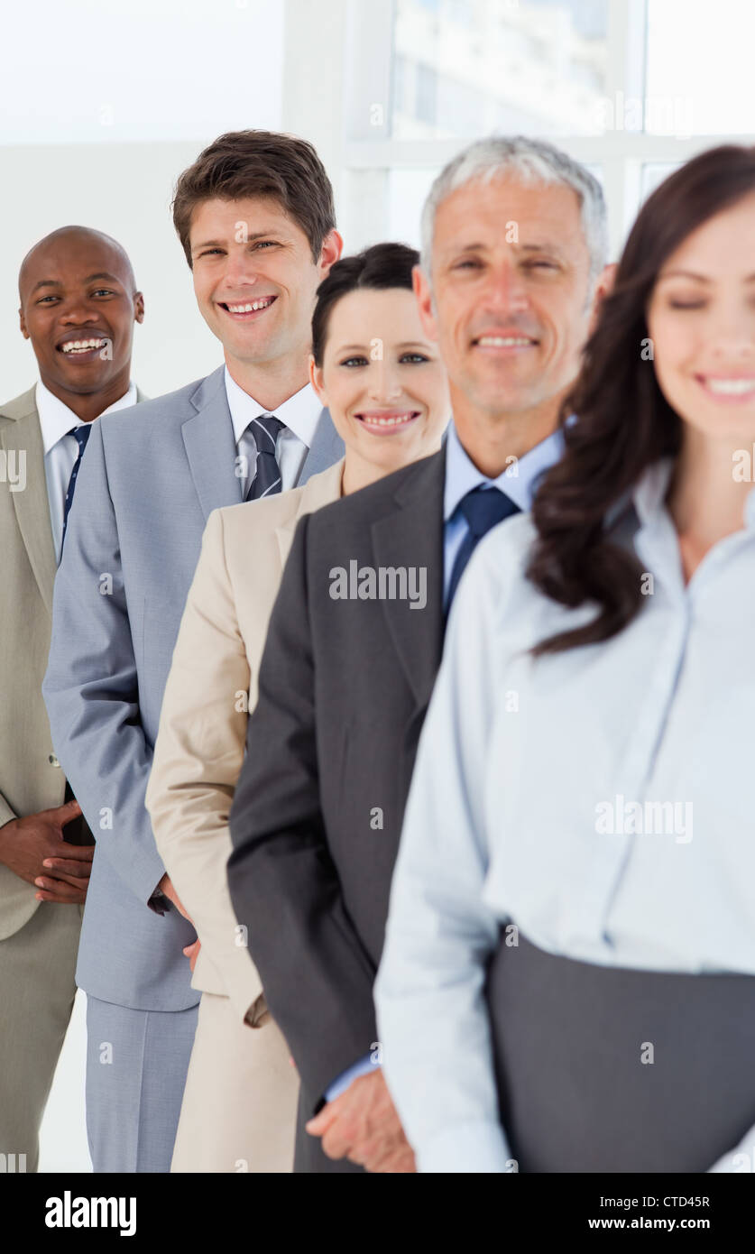 Young smiling employees which are laughing while following leaders ...