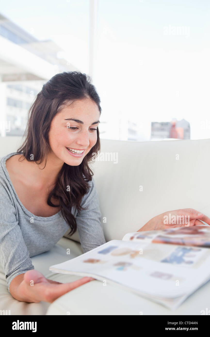 Beaming student reading a magazine Stock Photo - Alamy