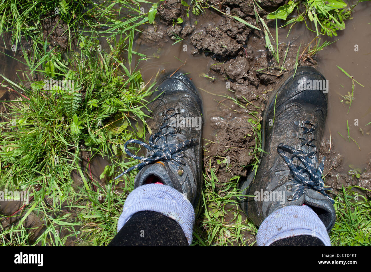 A woman's sodden hiking boots as she stands on waterlogged ground in ...