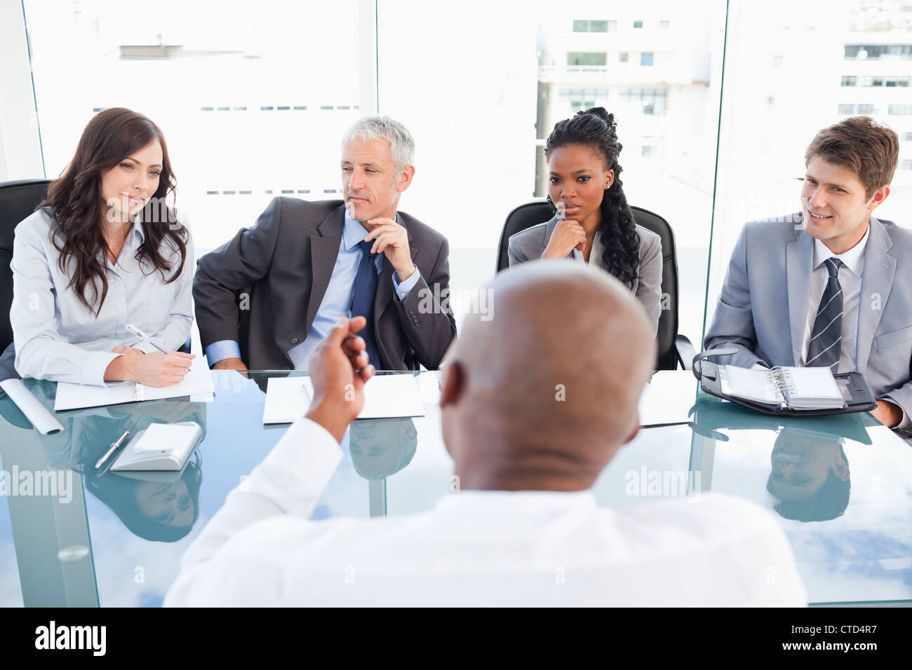 A manager and one employee talking to each other during a meeting with ...