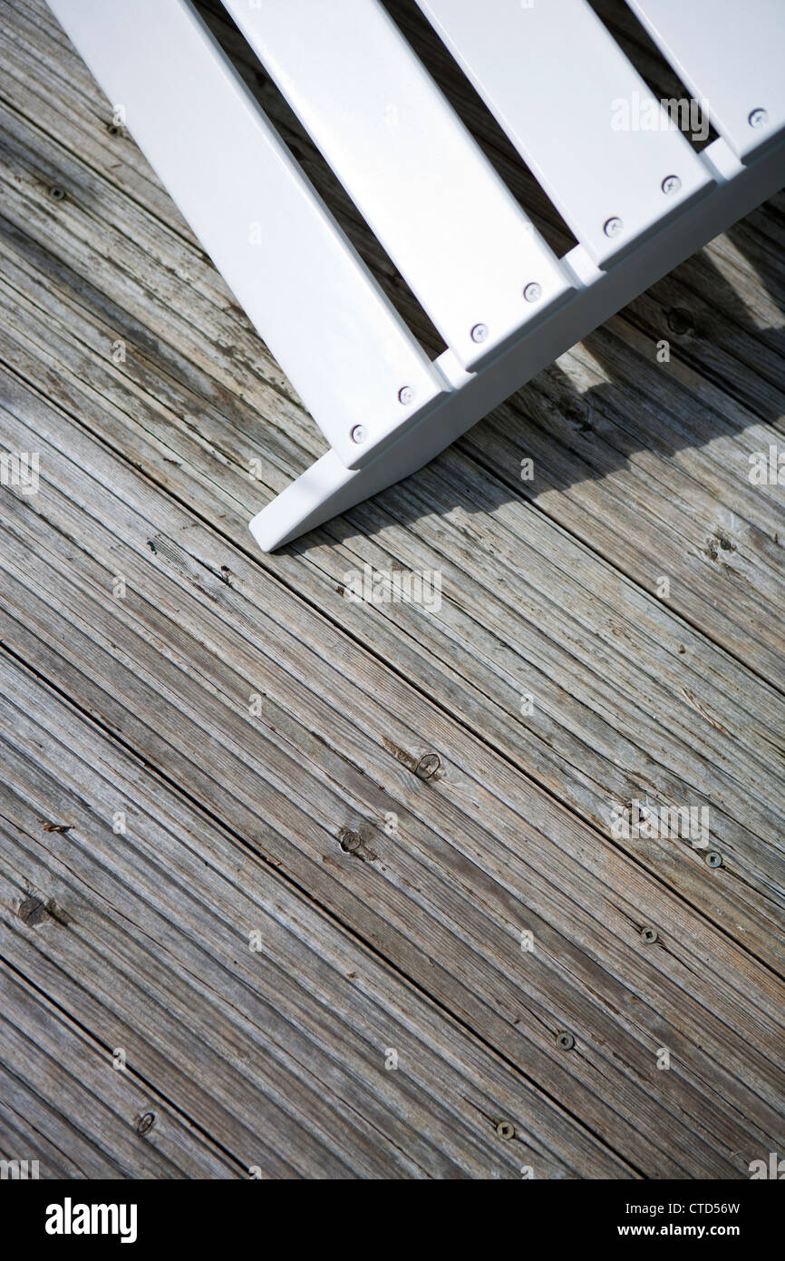 Close up of white garden furniture on untreated decking Stock Photo - Alamy