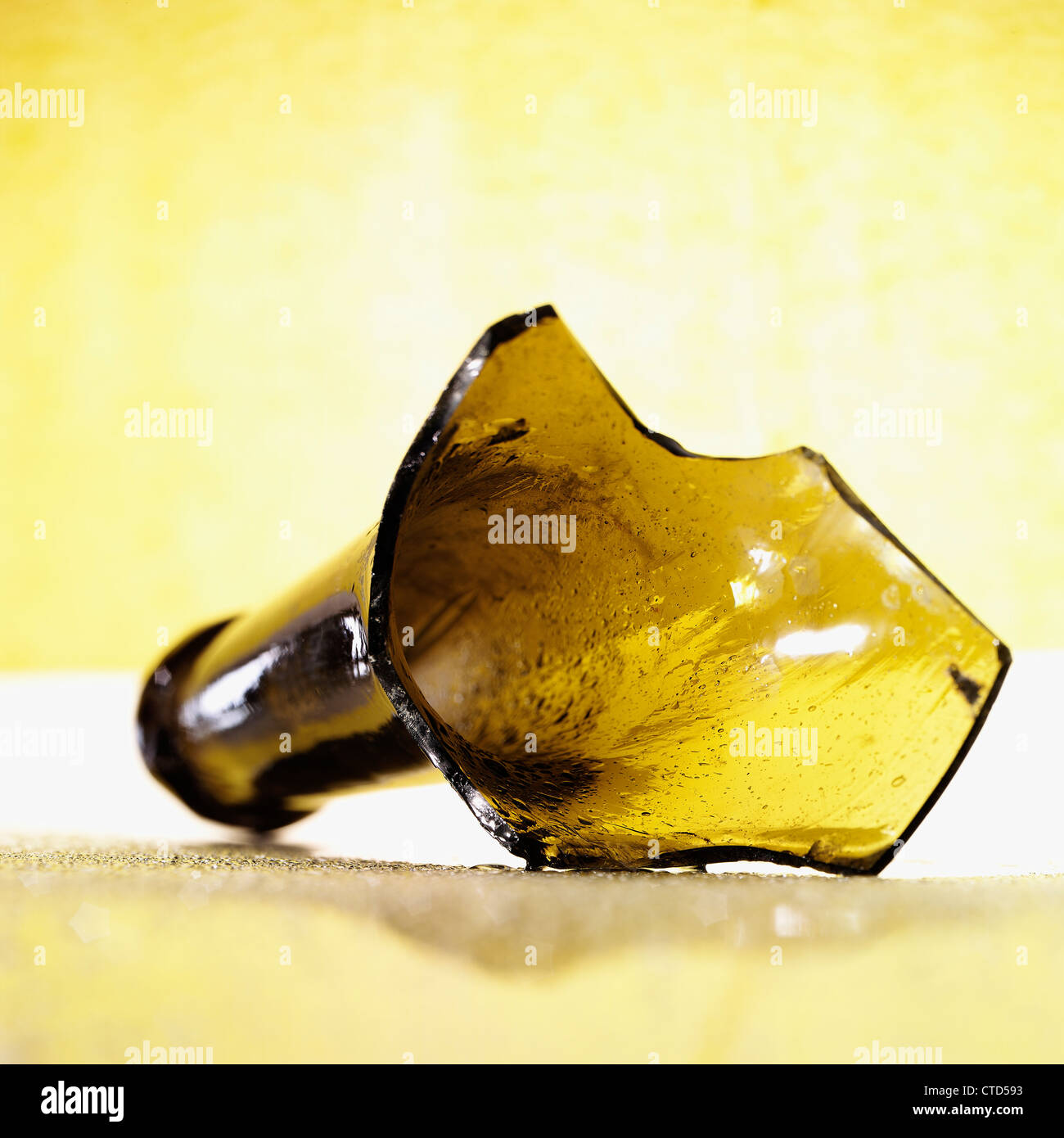 broken bottle top on yellow background Stock Photo - Alamy