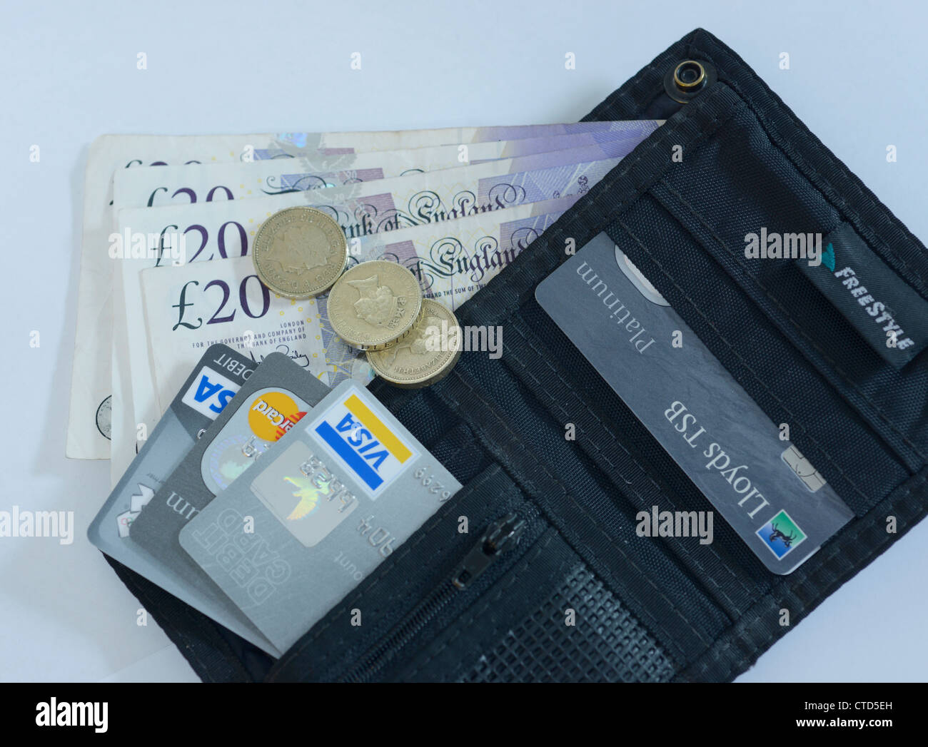 20 pound notes and one pound coins with credit card in wallet Stock ...