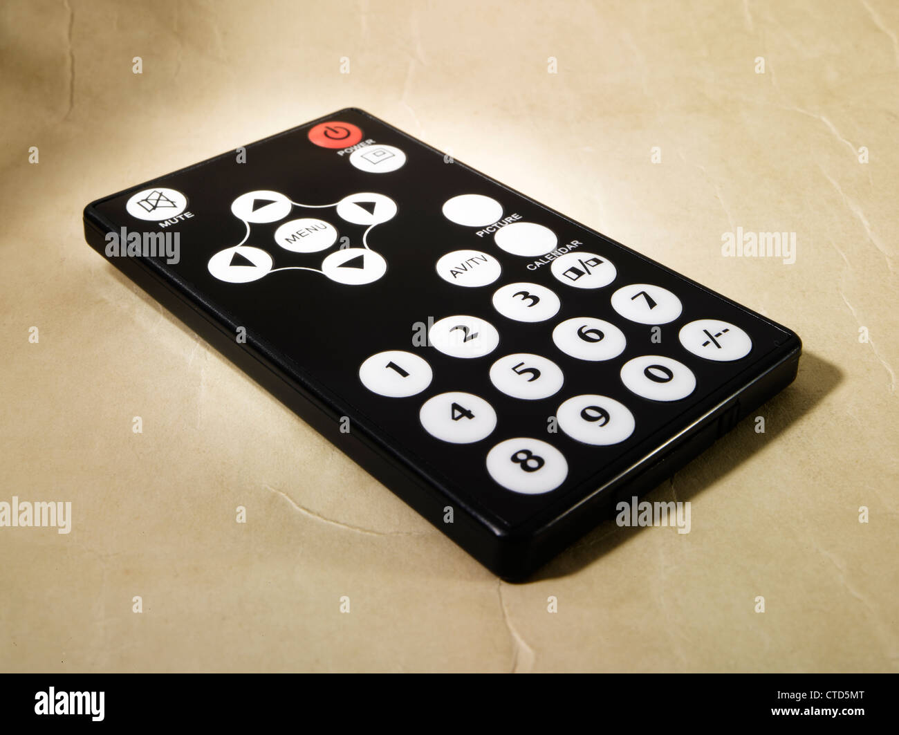 Black square remote control on a light brown background Stock Photo - Alamy