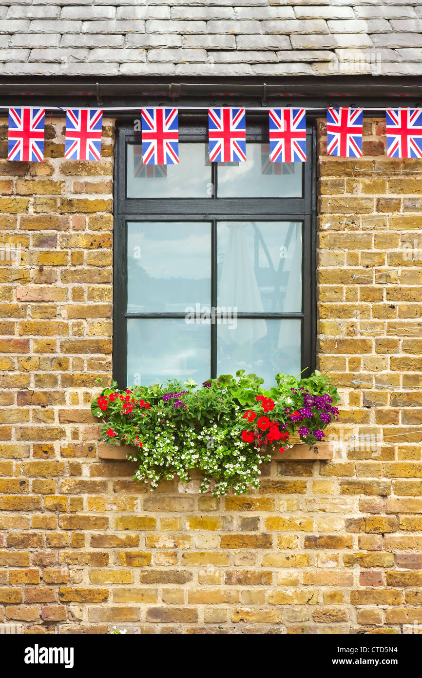 Window with Union Jack bunting above it Stock Photo - Alamy