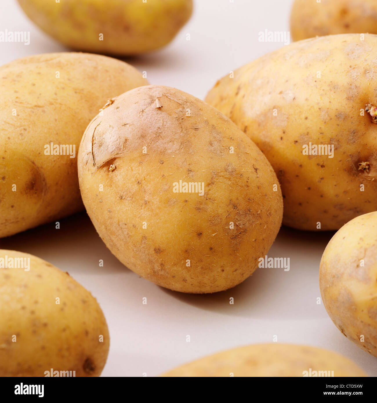 Close up of potatoes on a white background Stock Photo - Alamy