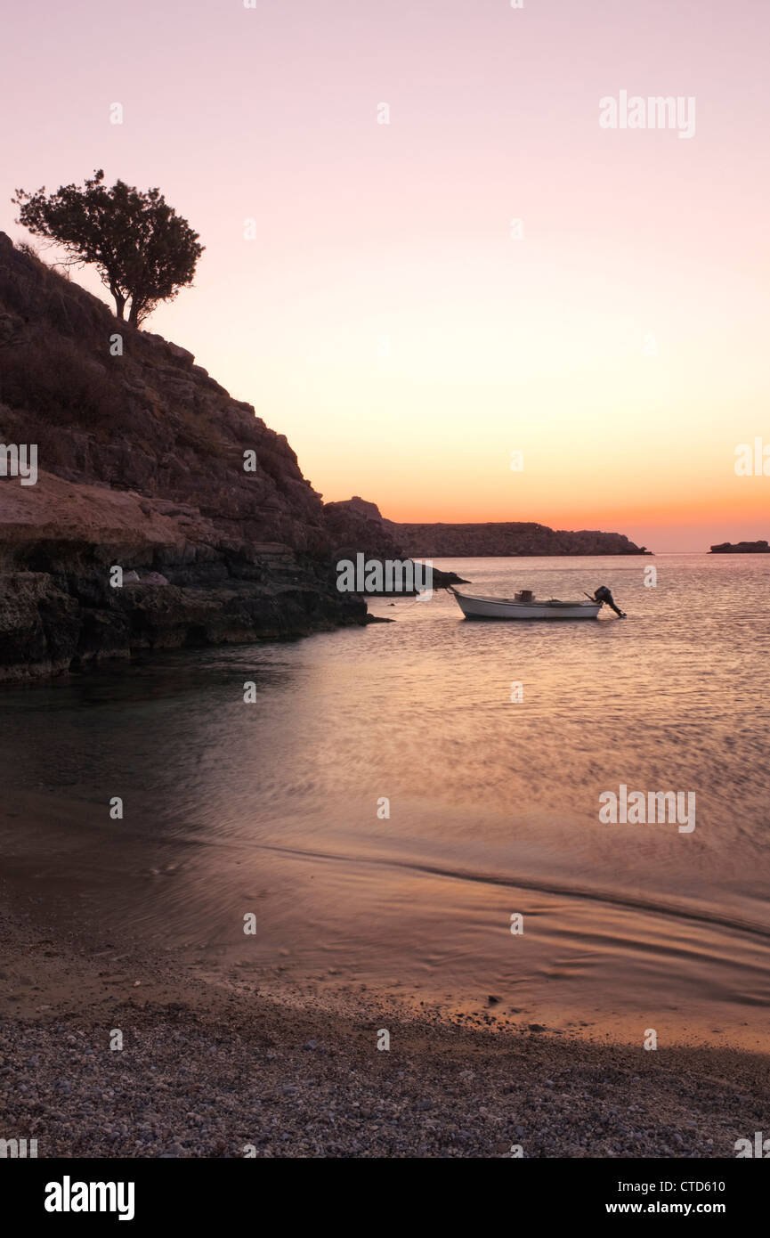 Sunrise on the greace sea with boat Stock Photo - Alamy