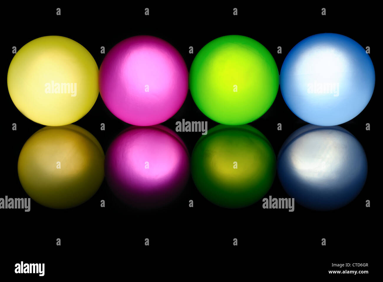 Illuminated color plastic balls in the dark Stock Photo - Alamy