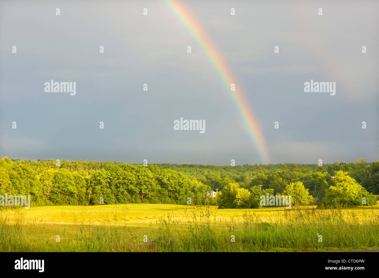 Rainbow over hay field on farm in Maine Stock Photo - Alamy