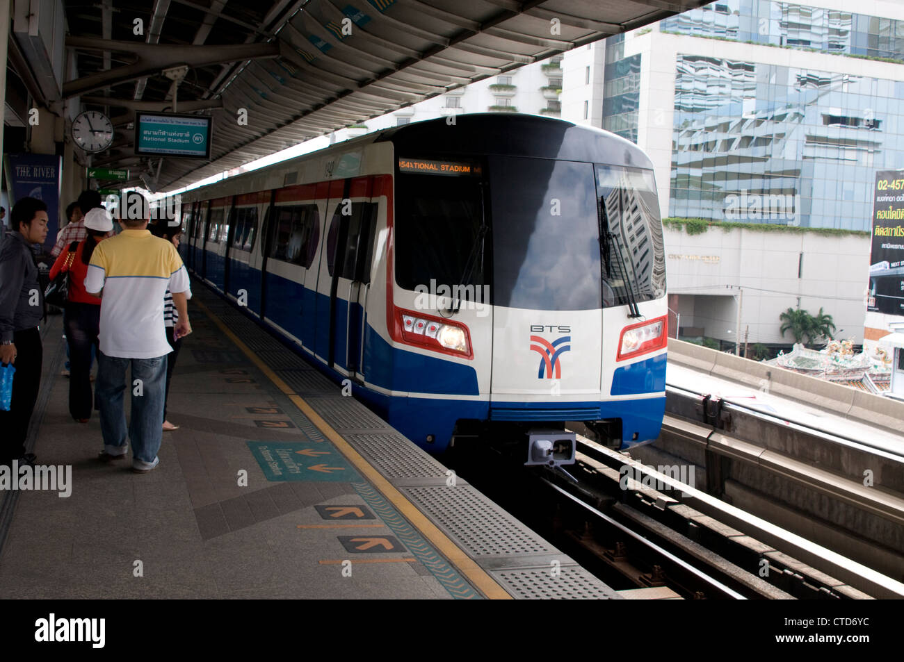 A modern sky train approaching an above ground rail station in Bangkok ...