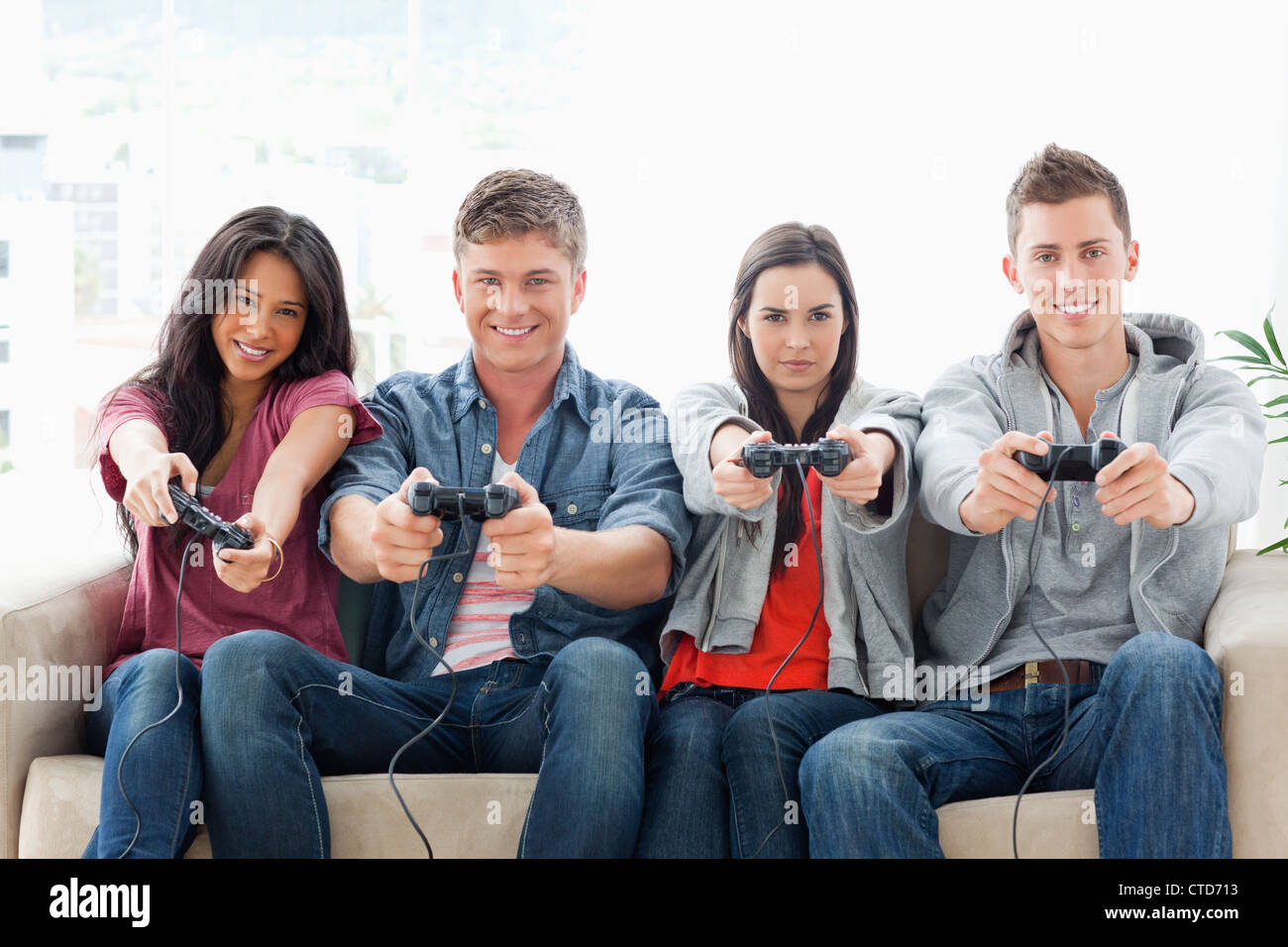 A group with arms out smiling as they play games together Stock Photo ...