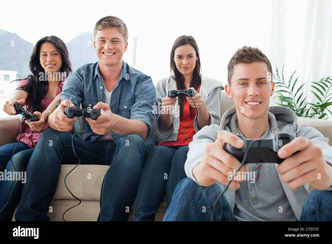 A happy group of friends playing games together while looking at the ...