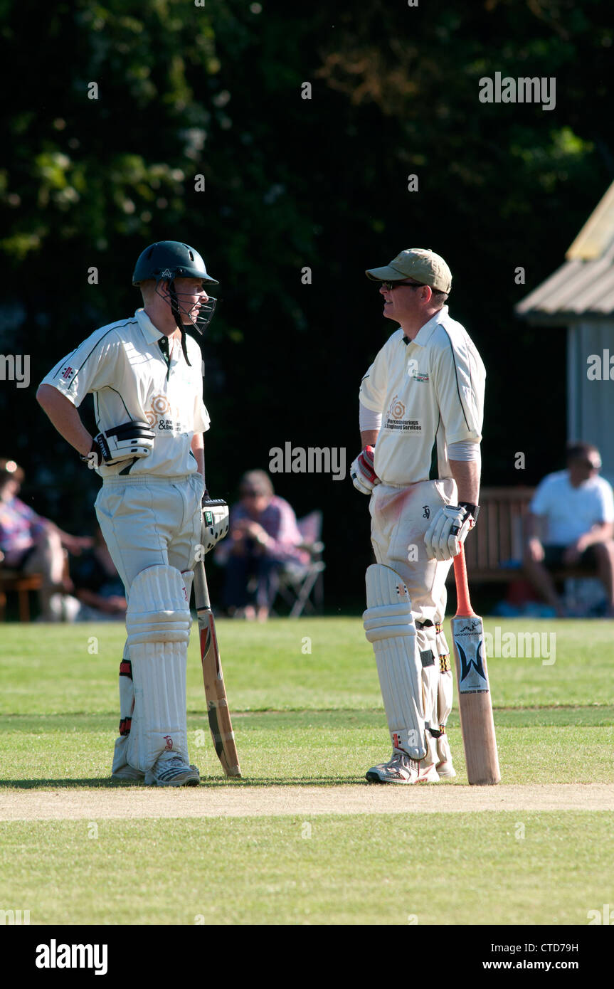 Village cricket, batsmen talking Stock Photo - Alamy