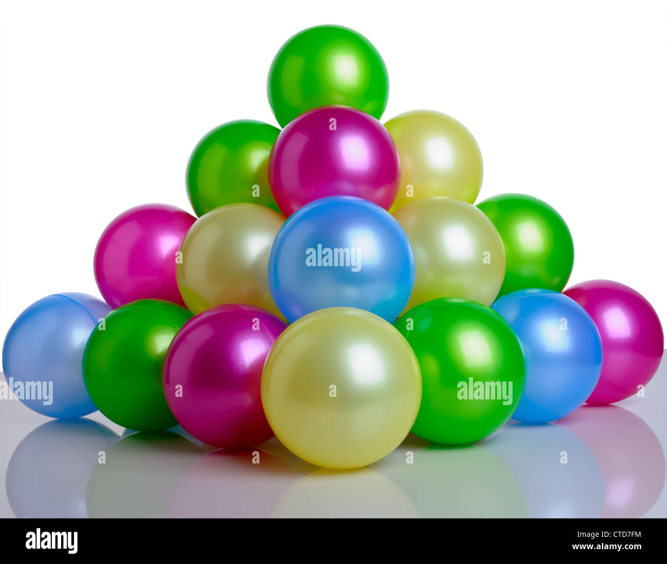 Pyramid of colored plastic balls on the reflecting surface Stock Photo ...