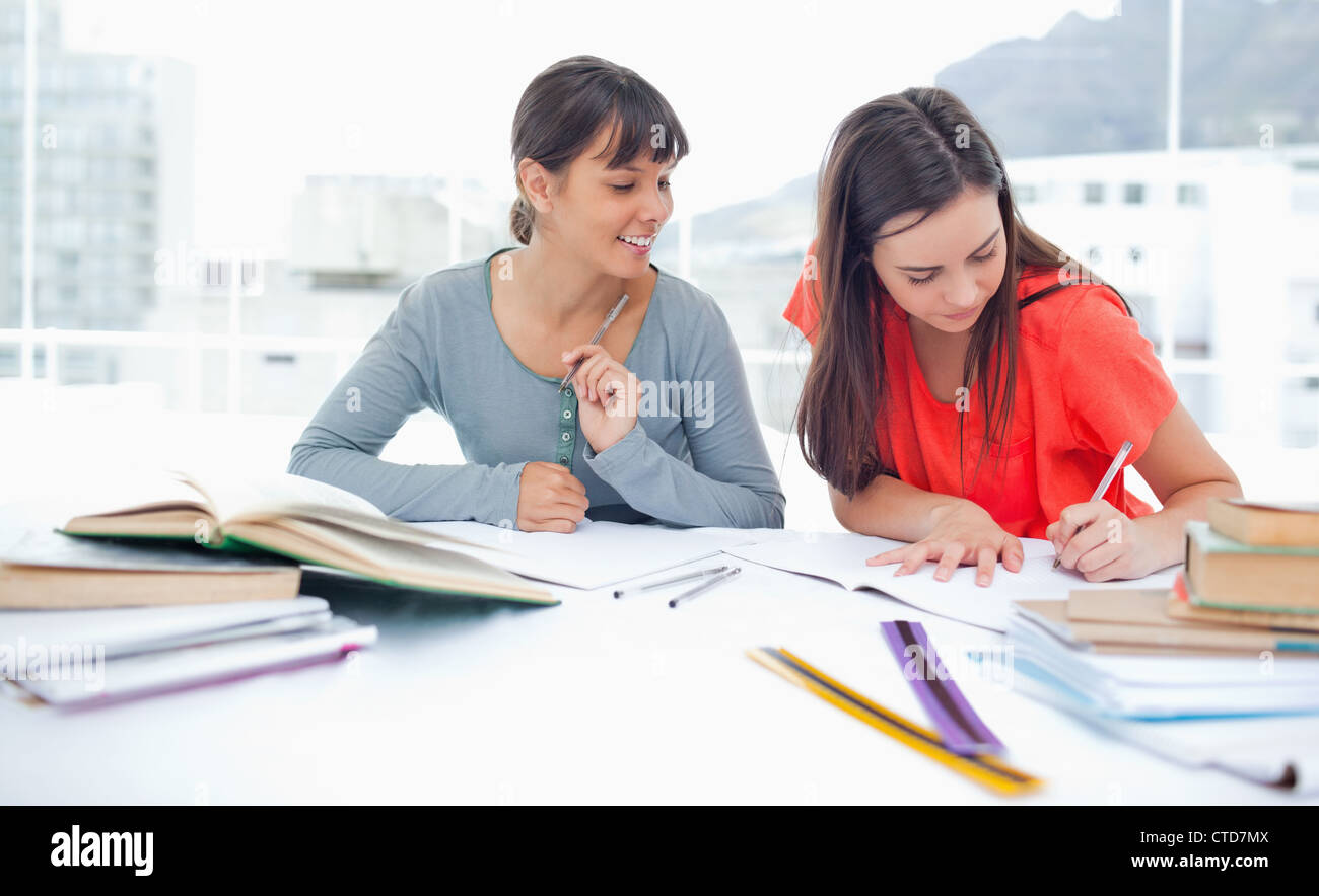 Two studying girls at home doing work Stock Photo - Alamy
