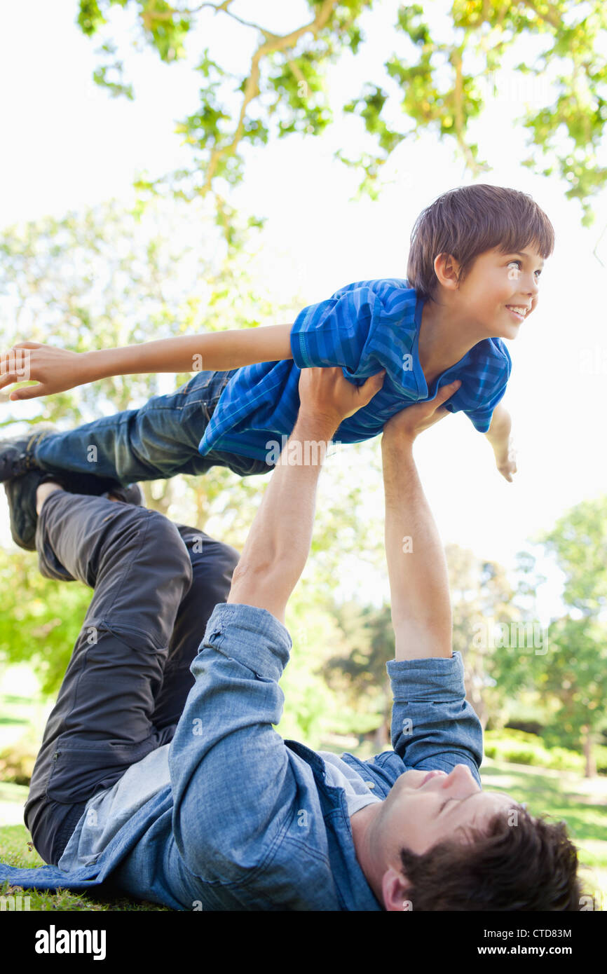 A father holding his son up above him Stock Photo - Alamy