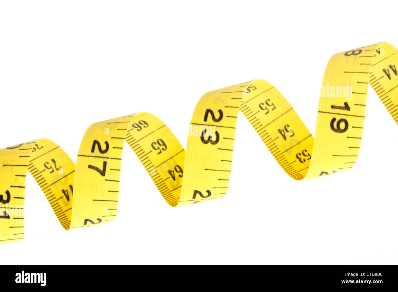 Yellow coiled tape measure on a white background Stock Photo - Alamy