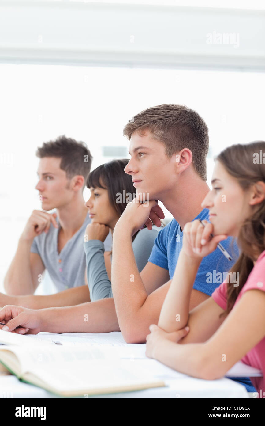 A group of students sitting in class listening Stock Photo - Alamy