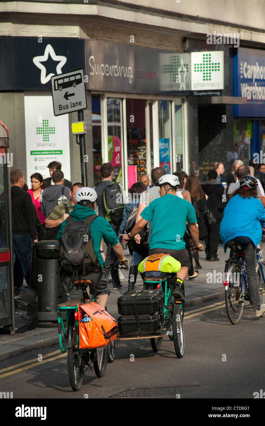 Rear view of cyclists cycling on a busy street in London, England Stock ...