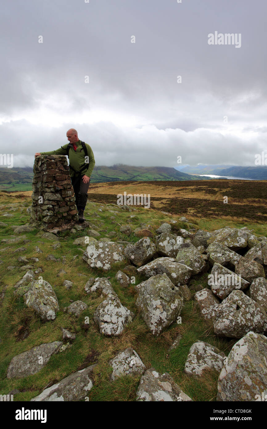 Adult male walker at summit cairn, Binsey fell, Northern Lakeland Fells ...
