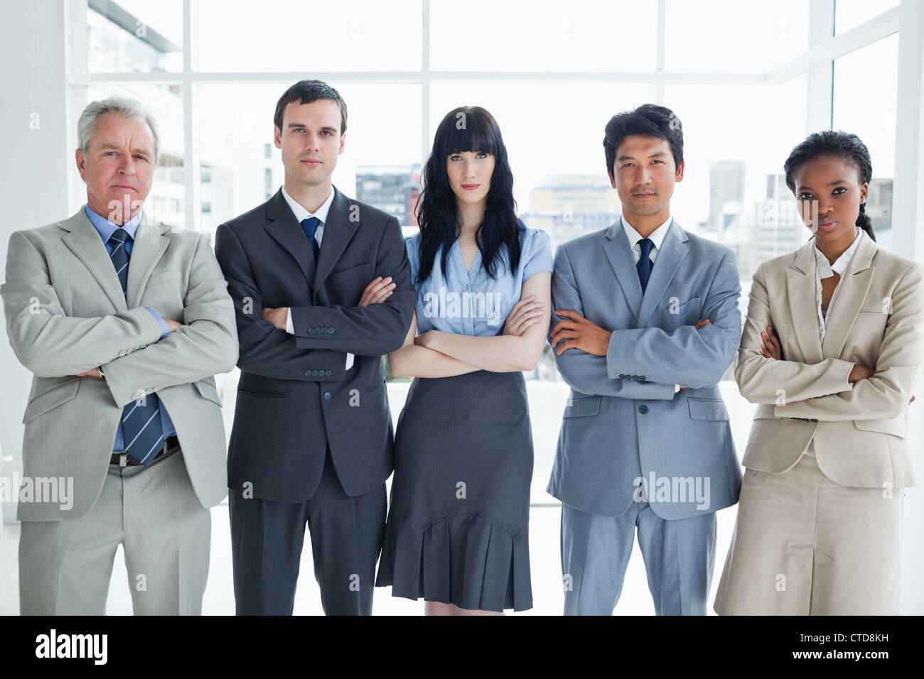 Five serious business people standing upright in a well-lit room Stock ...