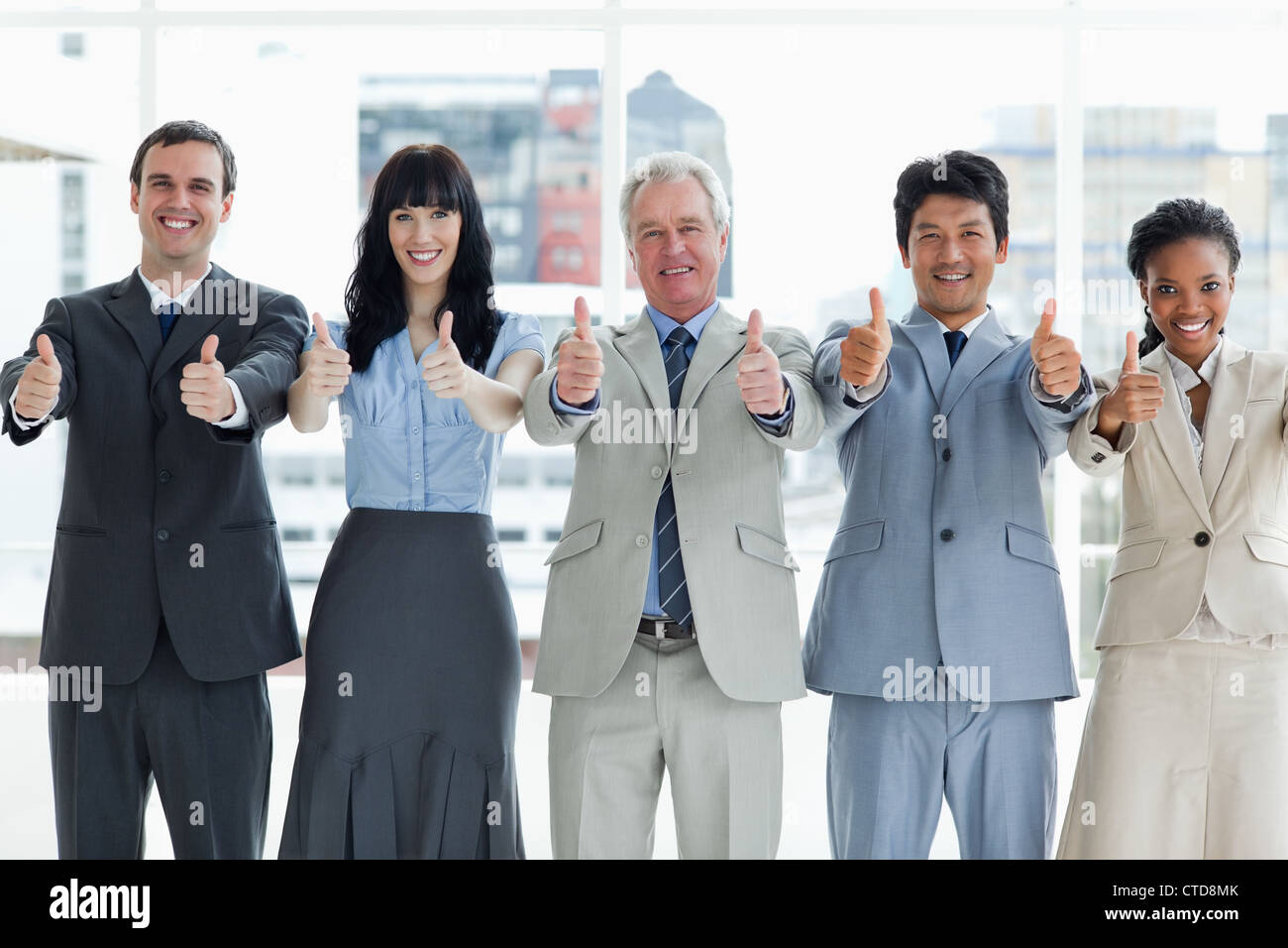 Business people showing their approval by putting their thumbs up Stock ...