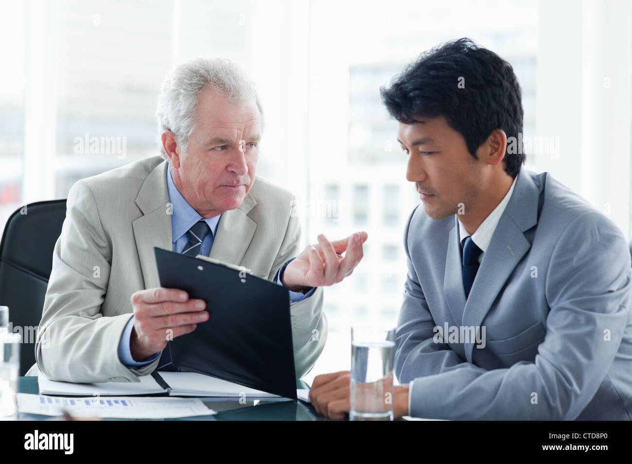 An employee attentively listening to his director Stock Photo - Alamy