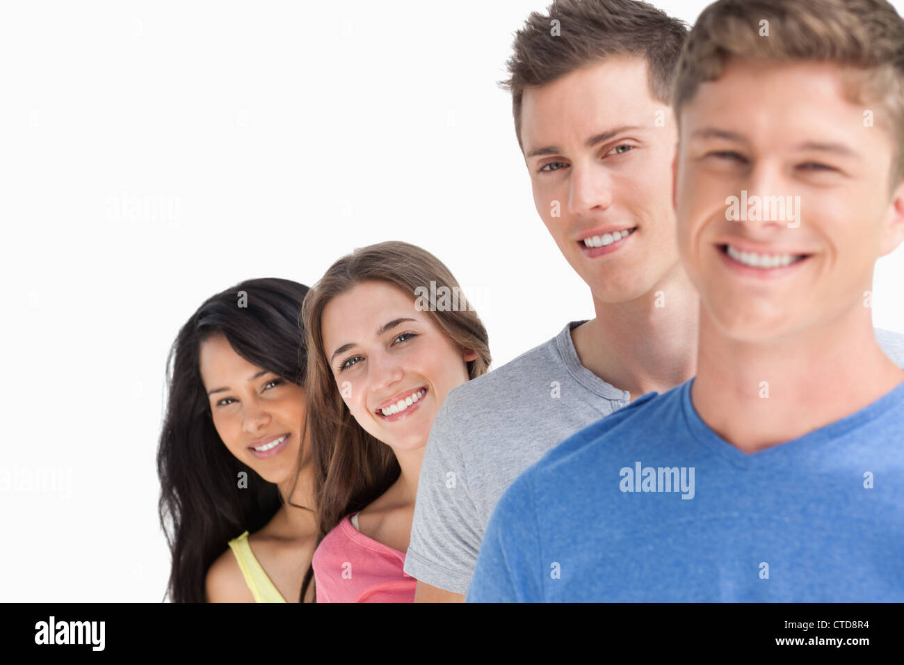 Four people standing in a line with each person angled out a little ...