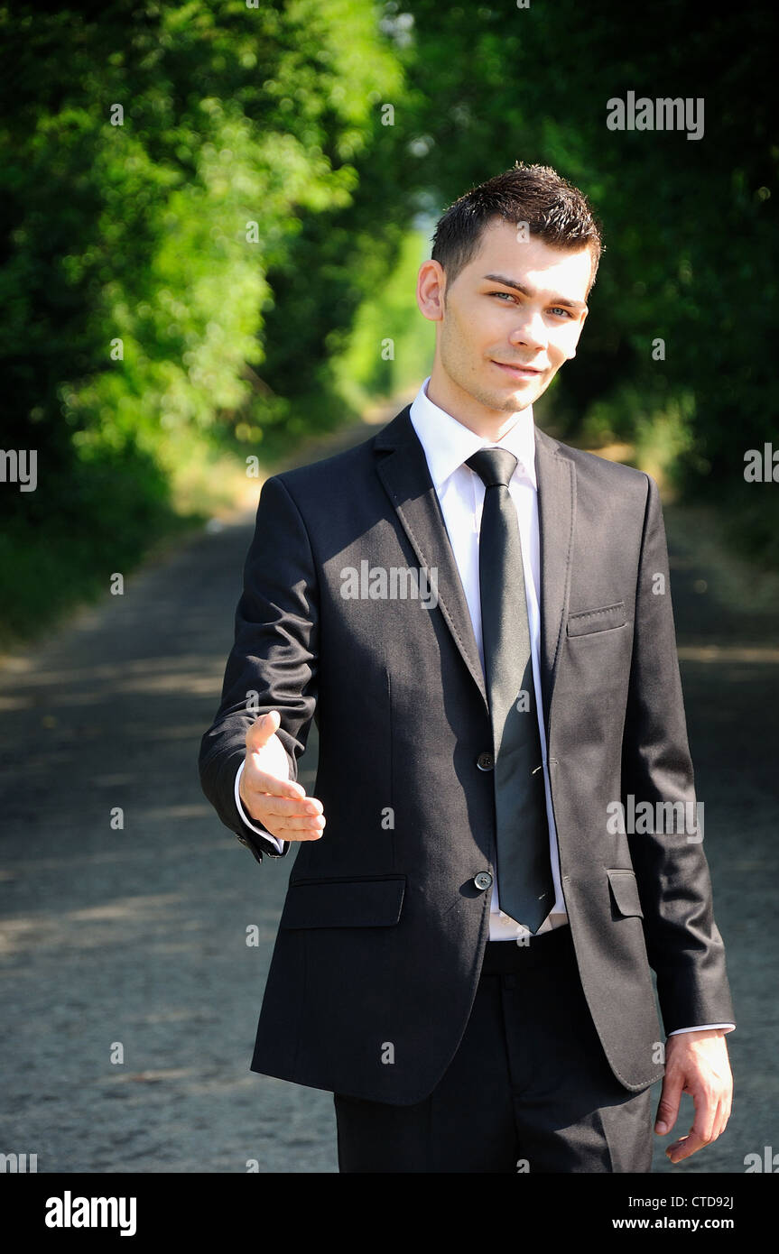 Business man handshake on road Stock Photo - Alamy