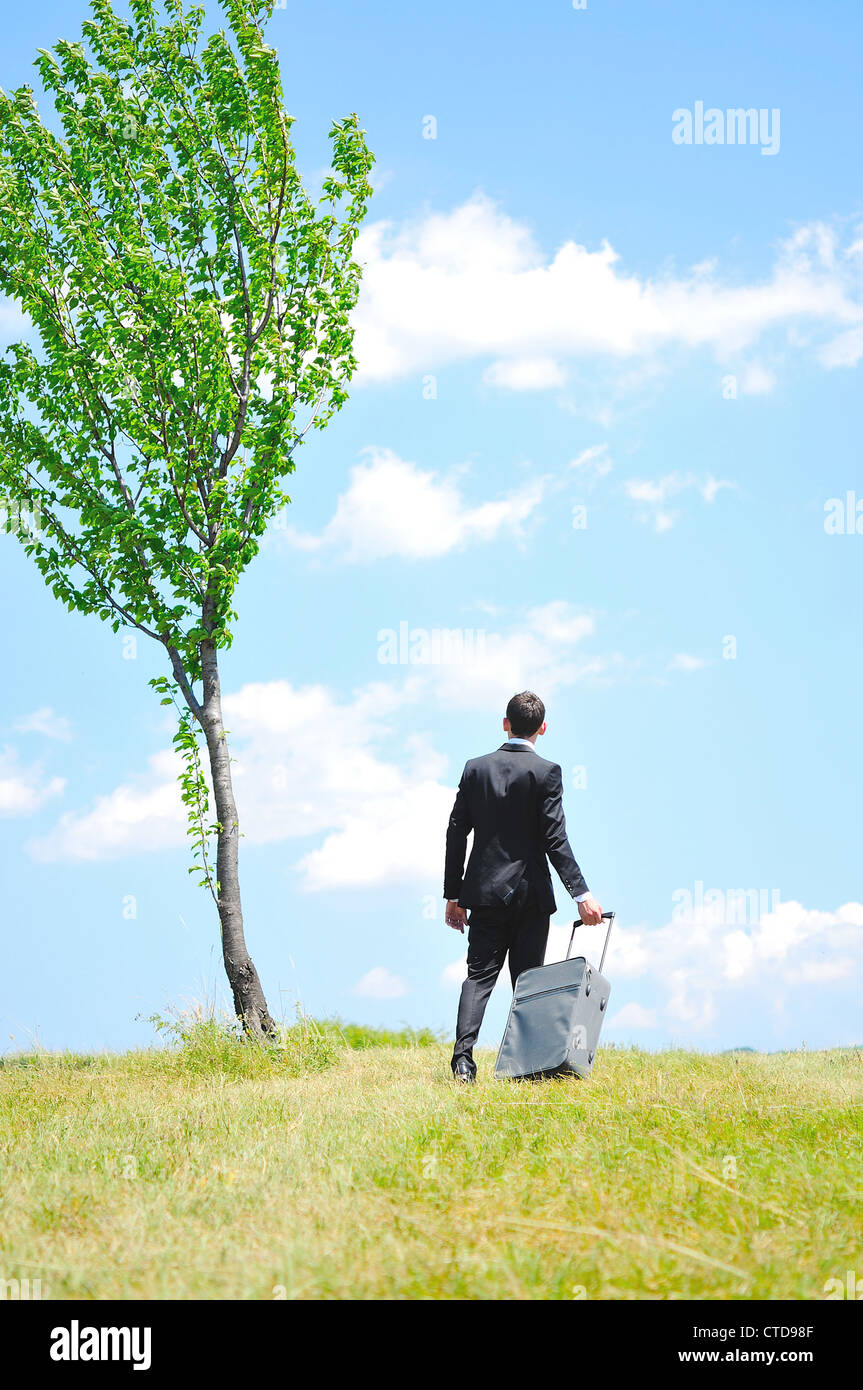 Business man walking in nature Stock Photo - Alamy