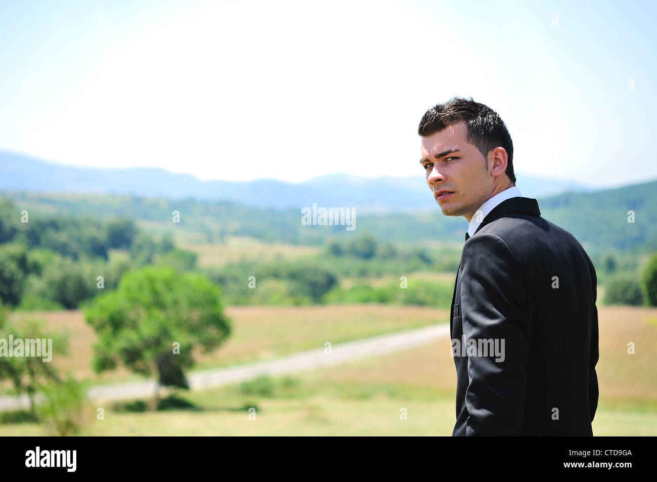 Business man standing in nature Stock Photo - Alamy